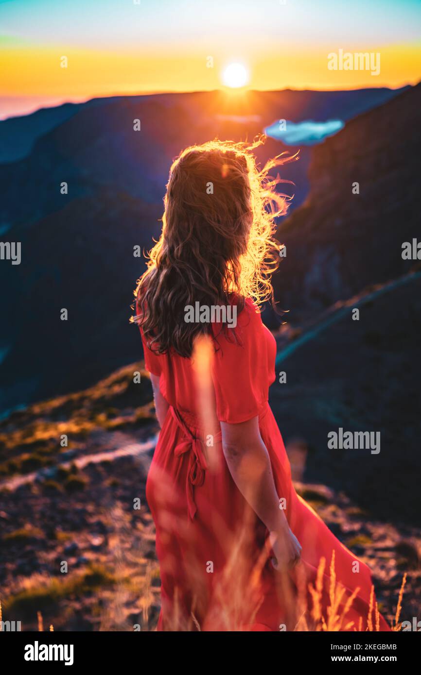 Description: Beautiful brown haired woman in red dress enjoying the ...