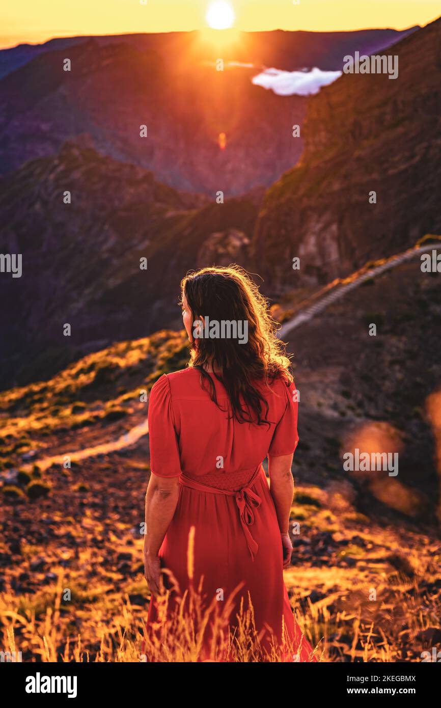 Description: Beautiful brown haired woman in red dress enjoying the ...
