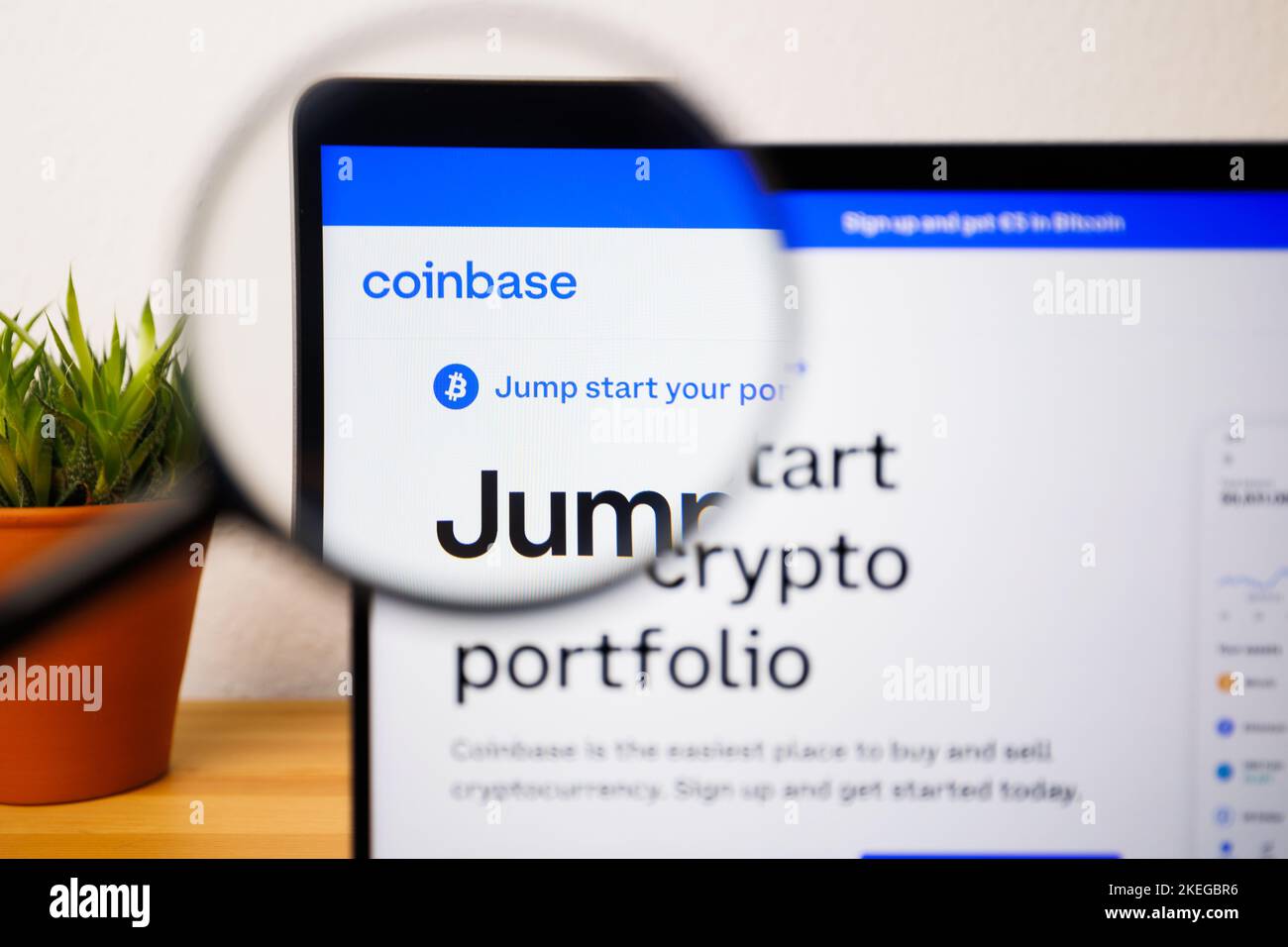 A logo of Coinbase on a laptop screen under a magnifying glass Stock ...