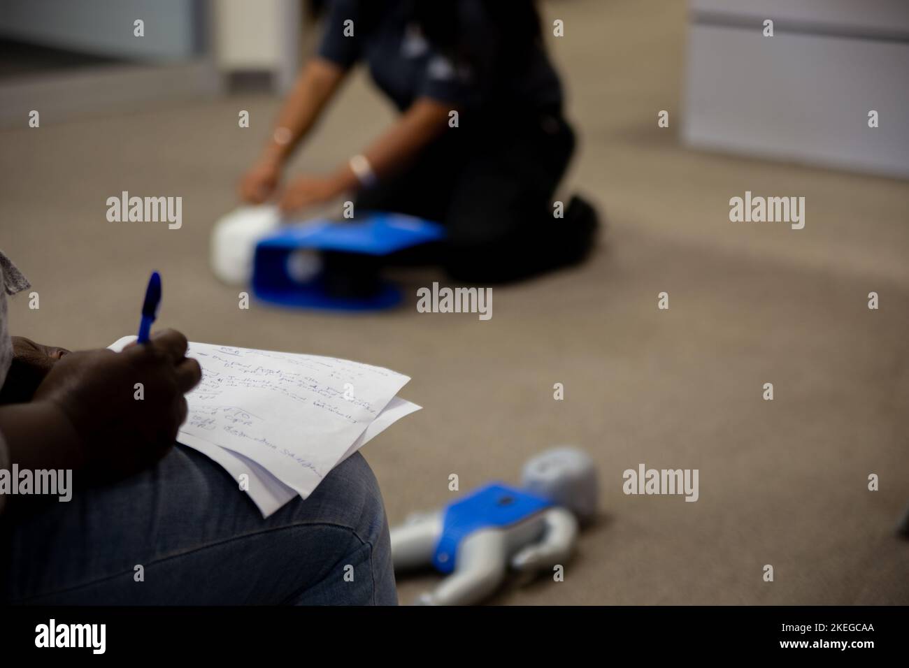 A person taking notes during first aid training Stock Photo - Alamy