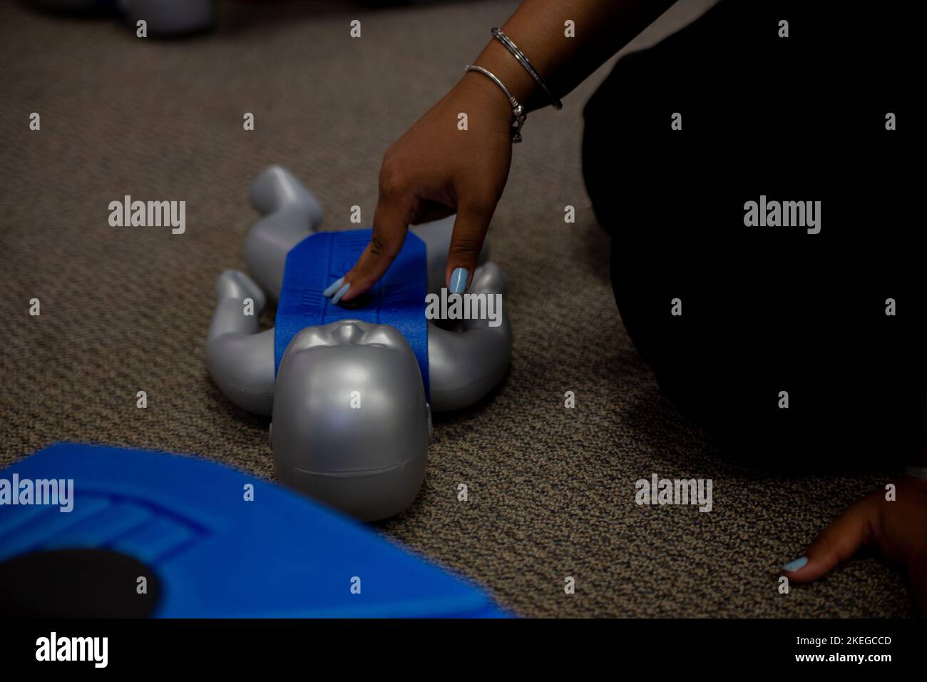 A woman performing first aid training Stock Photo - Alamy