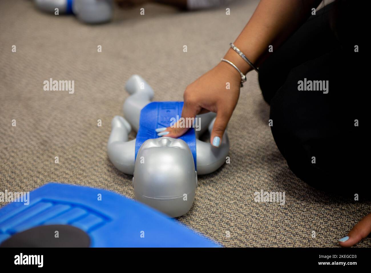A woman performing first aid training Stock Photo - Alamy