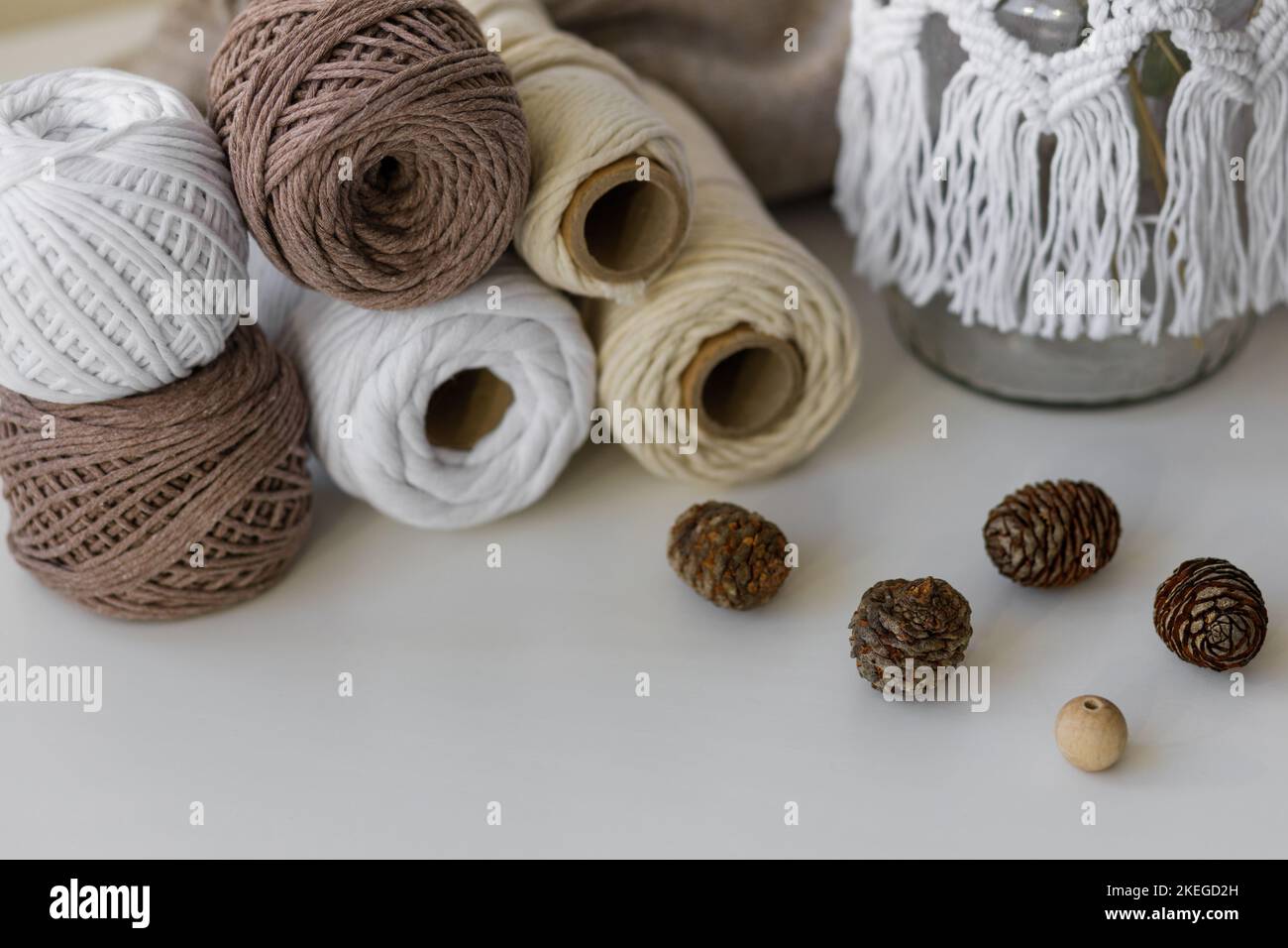 Composition from balls for knitting, cones, wooden beads and a jar ...