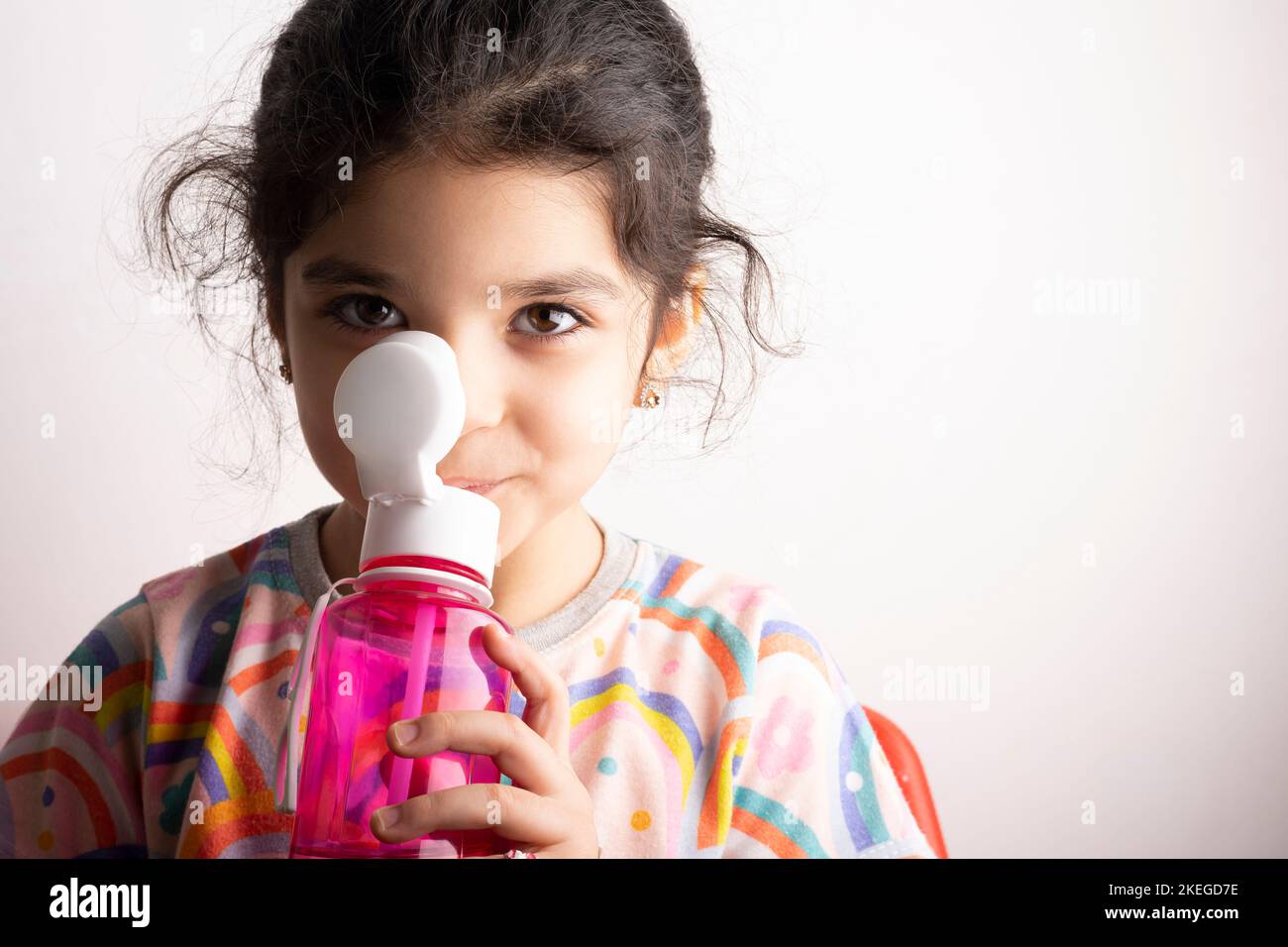Little girl drinking water from a pink plastic bottle Stock Photo - Alamy