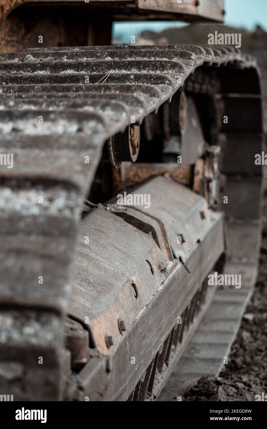 A selective focus of the caterpillar track with a blurry background ...