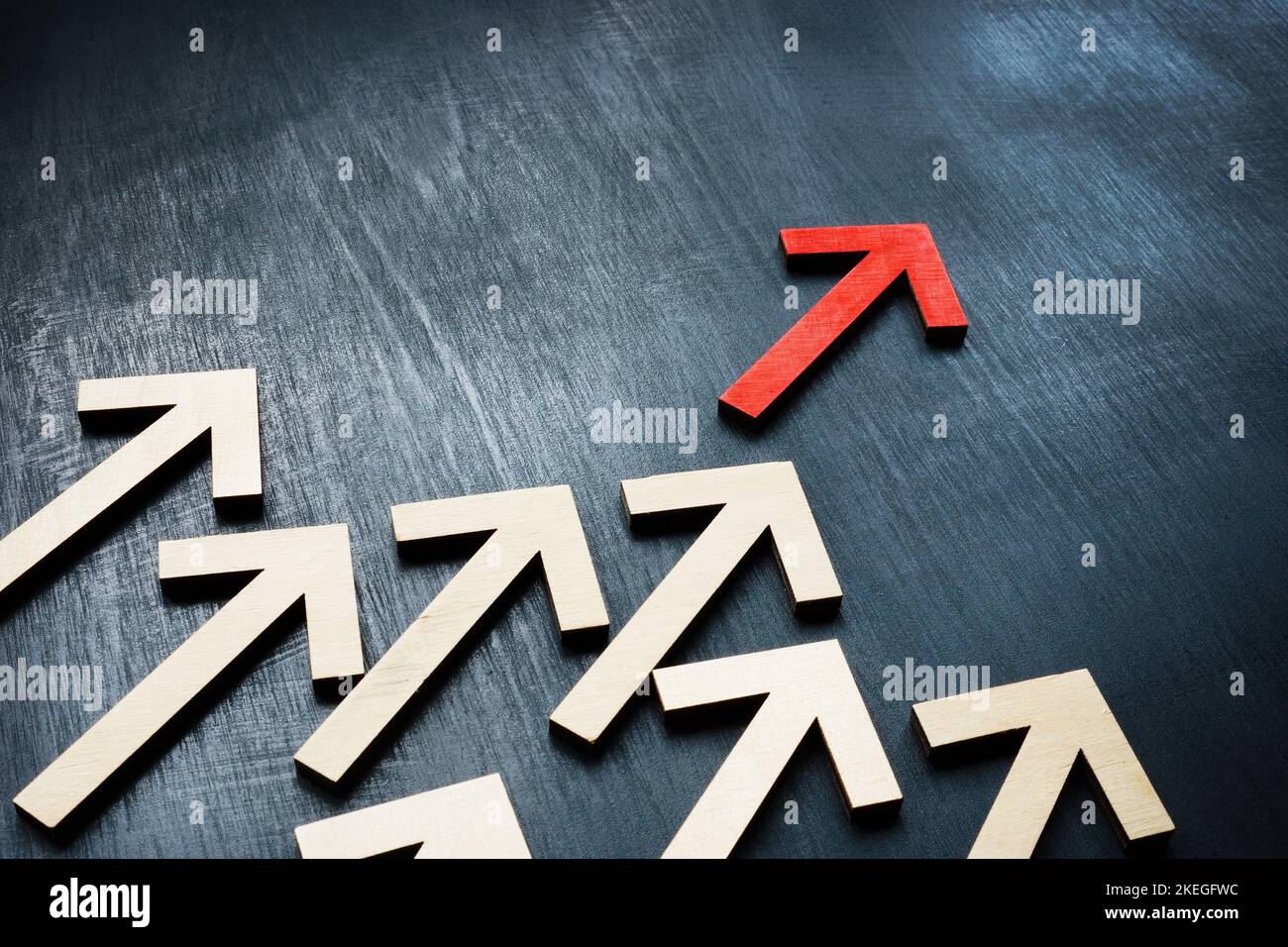 The red arrow in front of the wooden ones symbolizes leadership and ...