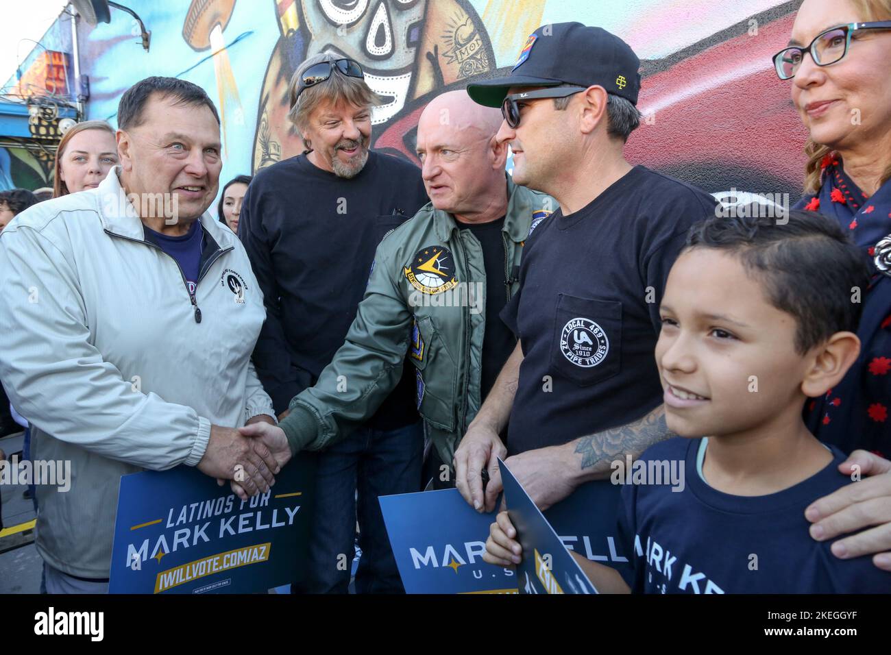 Senator Mark Kelly signs campaign posters amongst his supporters after ...