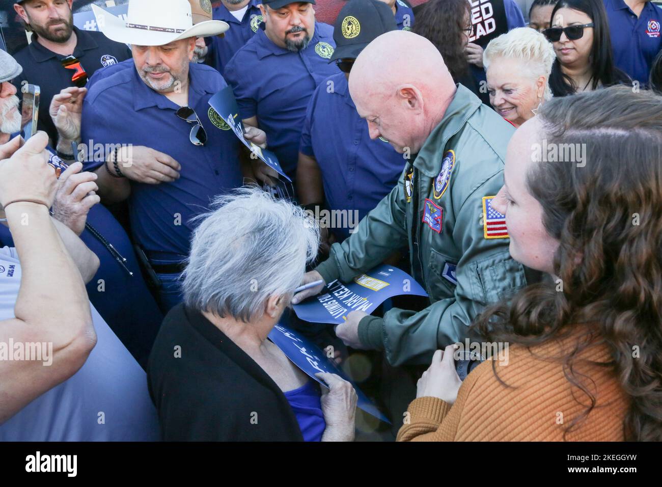 Senator Mark Kelly signs campaign posters amongst his supporters after ...