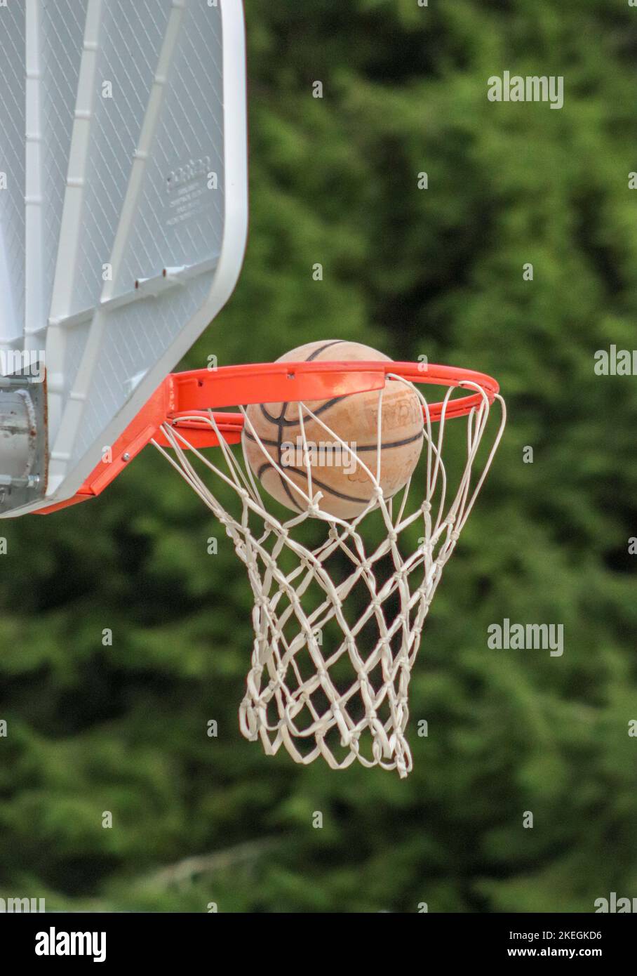 A vertical shot of a ball going through the hoop Stock Photo - Alamy