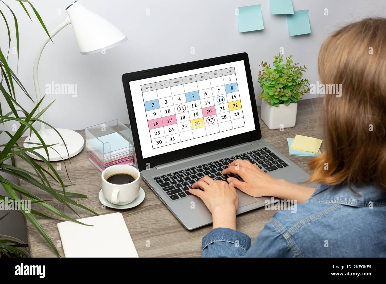 Woman planning monthly business meetings, schedule and goals using ...