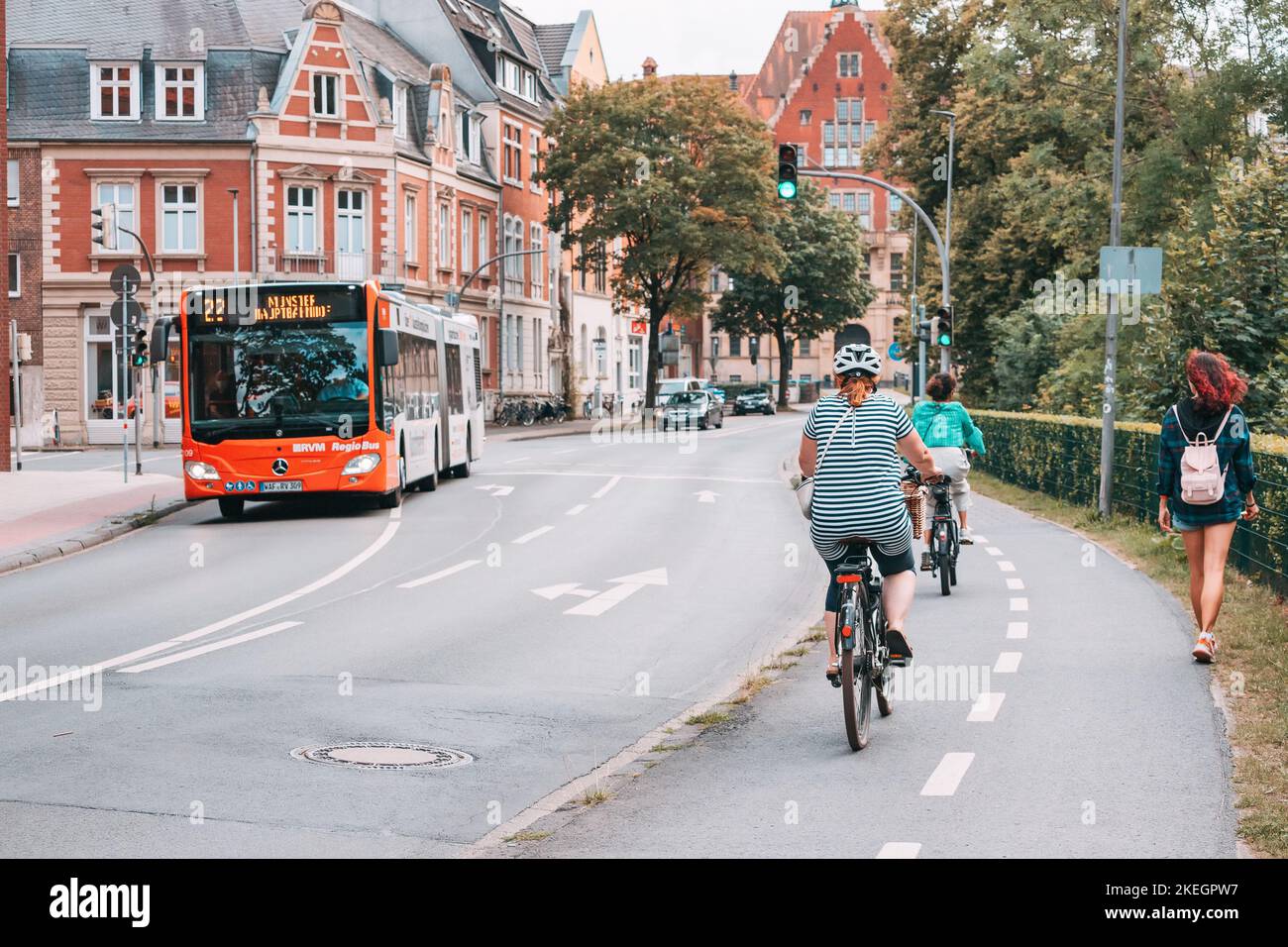 25 July 2022, Munster, Germany: Cyclists ride along the bike path on ...