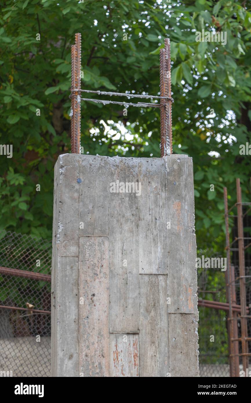 Vertical shot of newly built concrete column for the future house close ...
