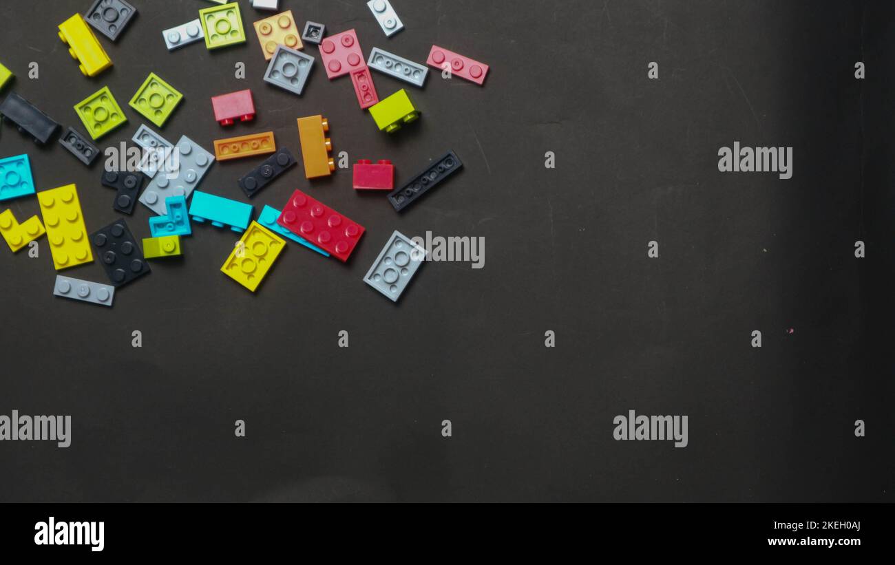 Plastic toy blocks on black background Stock Photo - Alamy