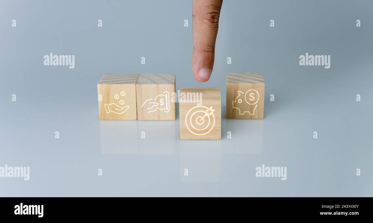 Hand pointing at one wood cube block with target icon . Concept of ...