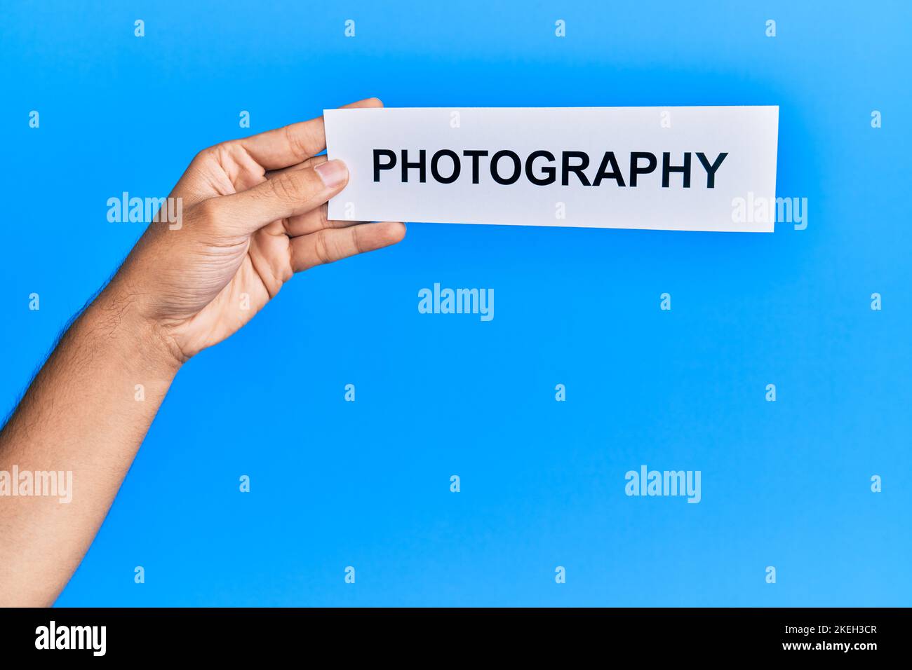Hand of caucasian man holding paper with photography word over isolated ...