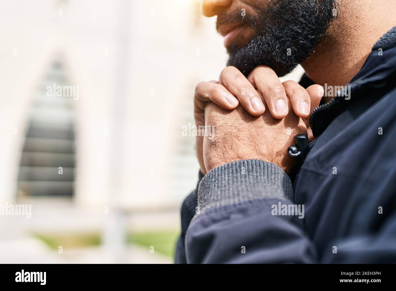 Young hispanic man praying with closed eyes at park Stock Photo - Alamy