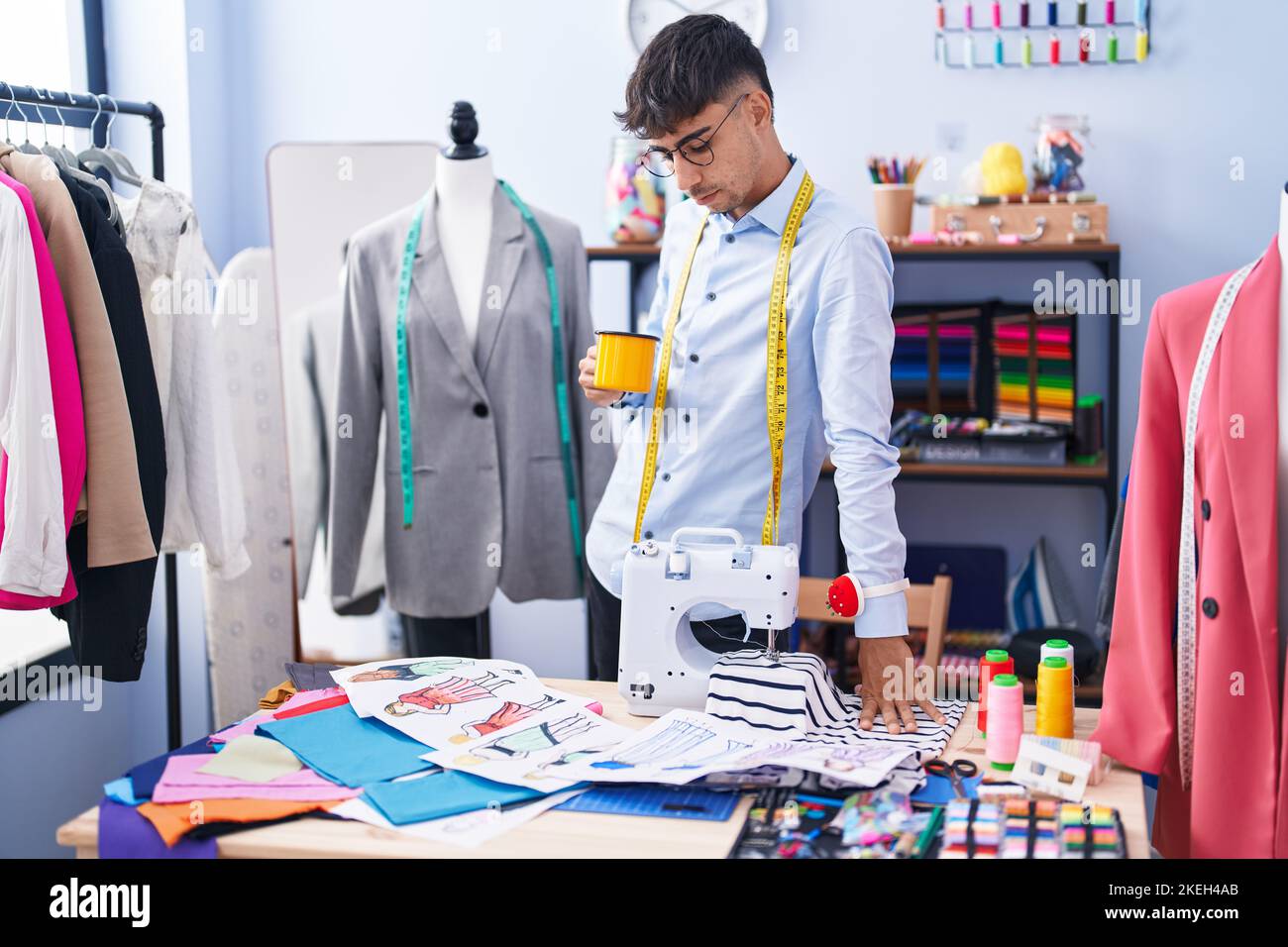 Serious handsome tailor sewing hi-res stock photography and images - Alamy