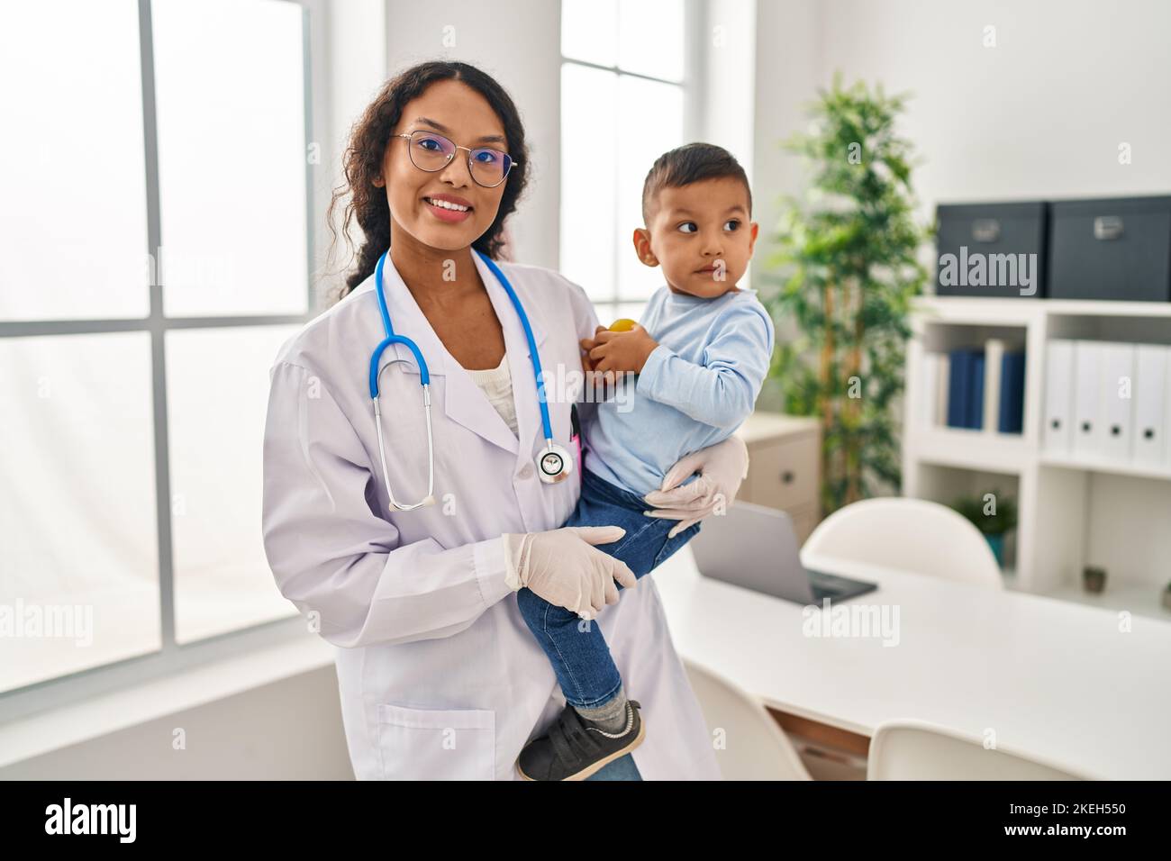 Mother and son pediatrician and patient hugging each other at clinic ...