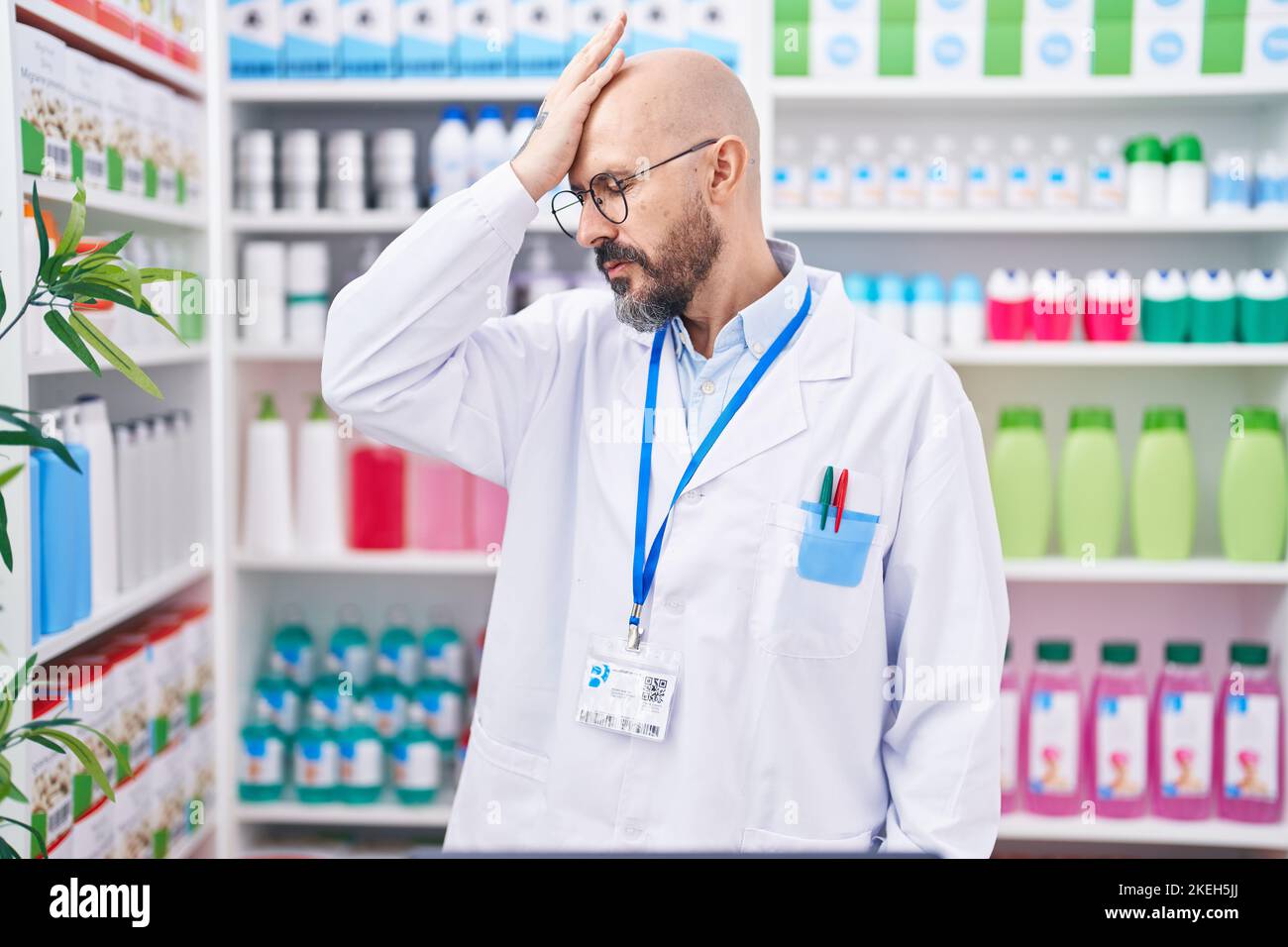Hispanic man with tattoos working at pharmacy drugstore surprised with ...