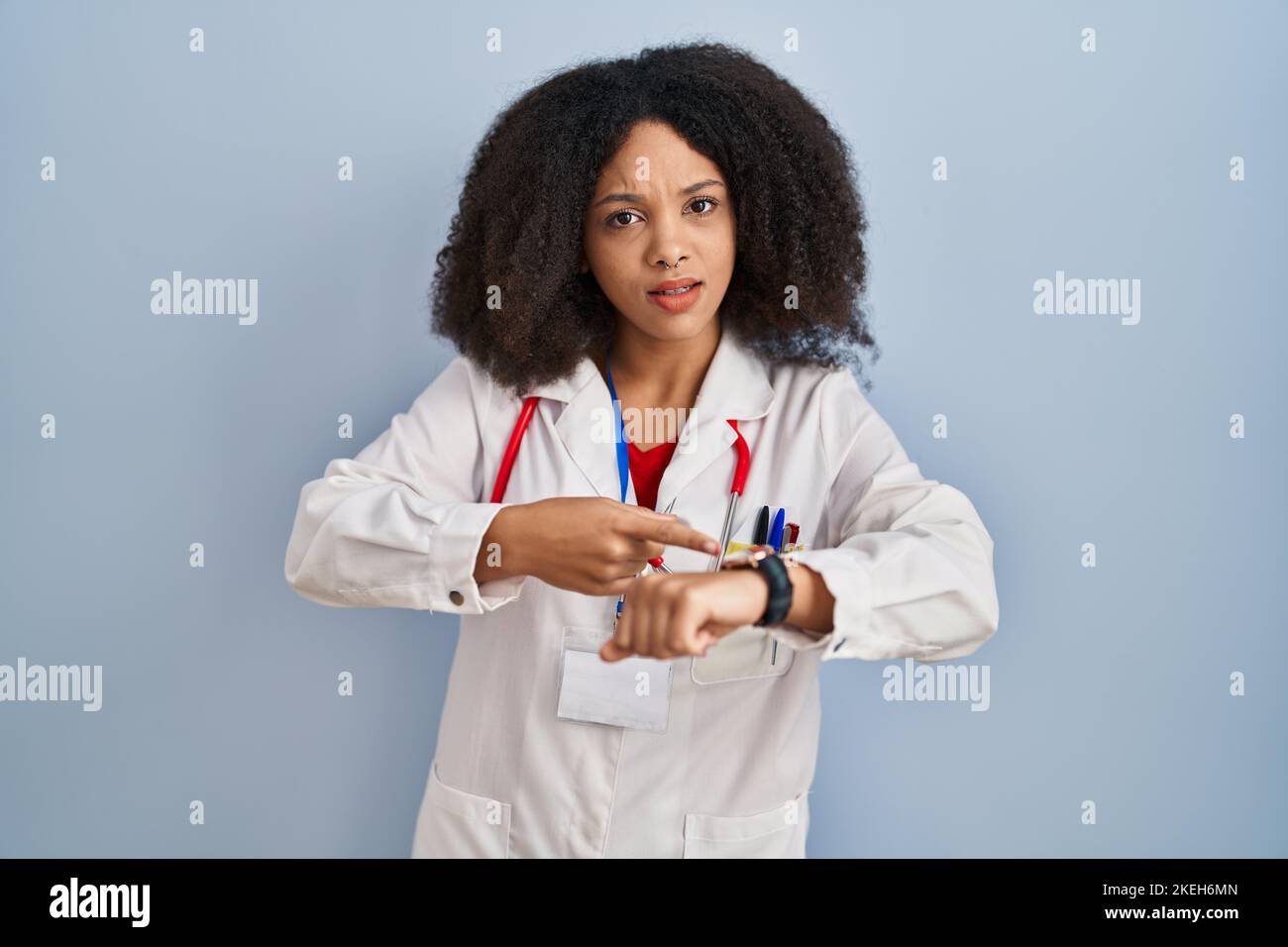 Young african american woman wearing doctor uniform and stethoscope in ...