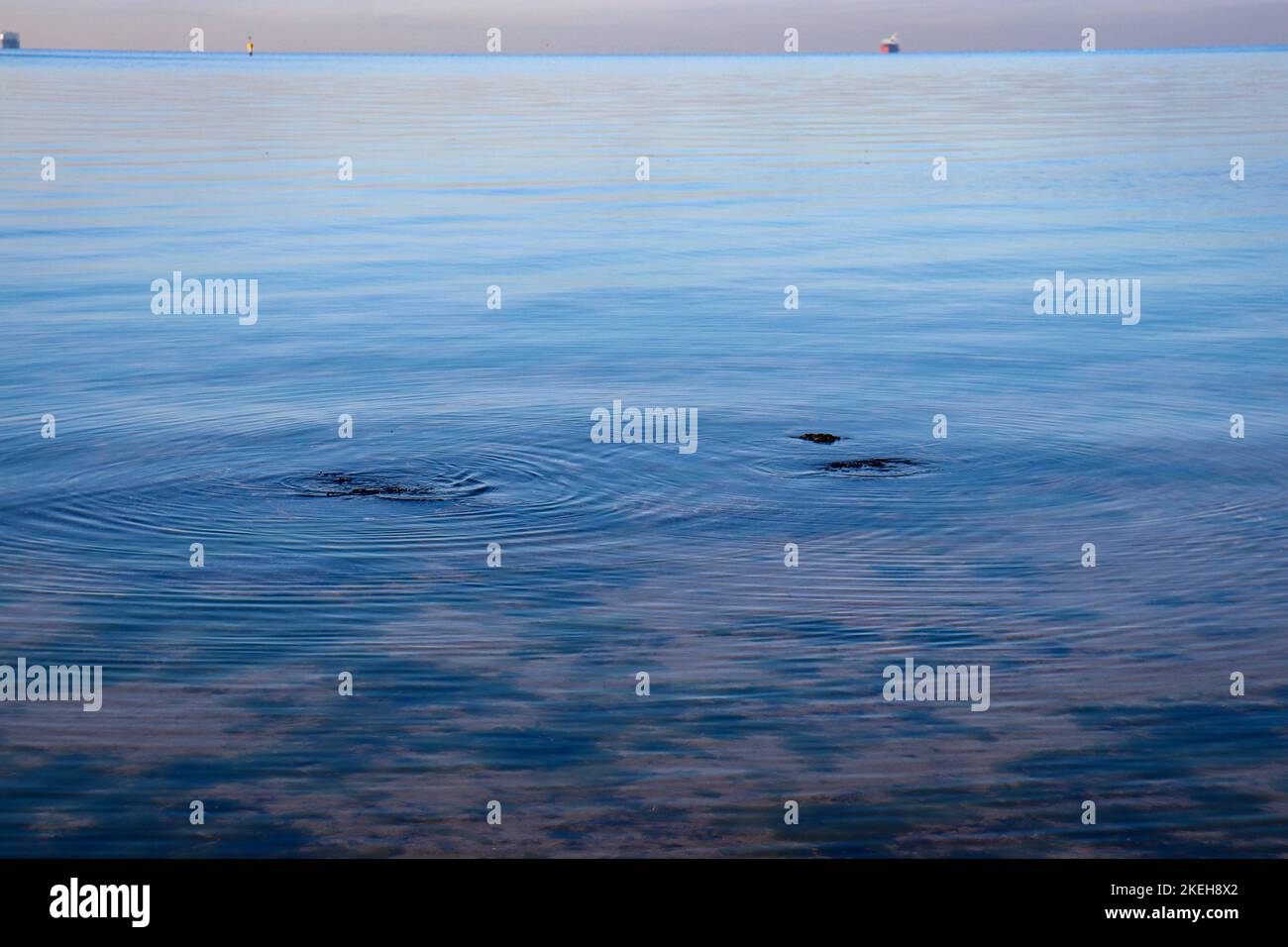 An aerial view of the calm ocean with circle ripples Stock Photo - Alamy