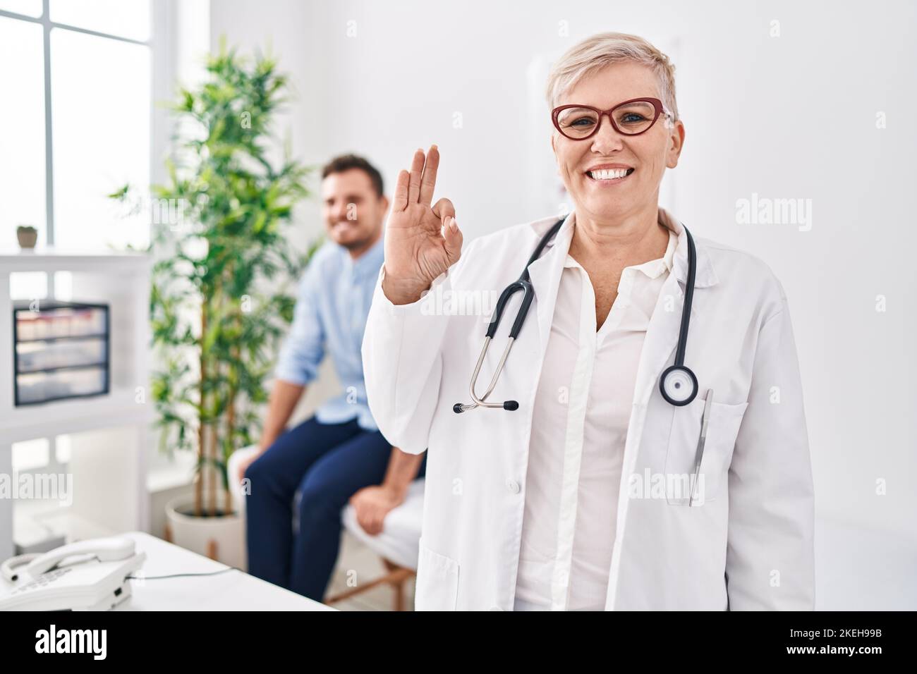 Female doctor wearing uniform and stethoscope at medical clinic doing ...