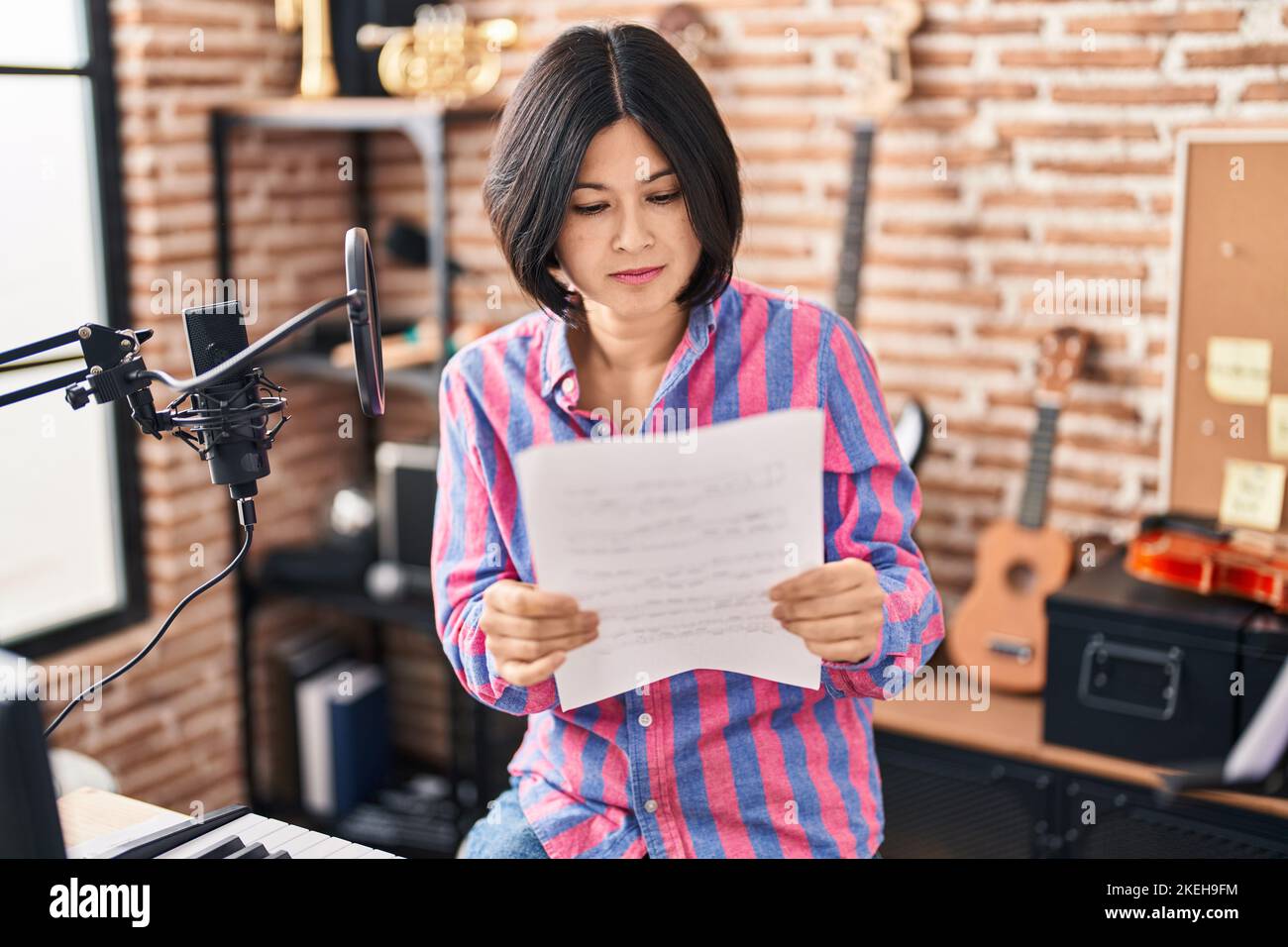 Young chinese woman artist singing song at music studio Stock Photo - Alamy