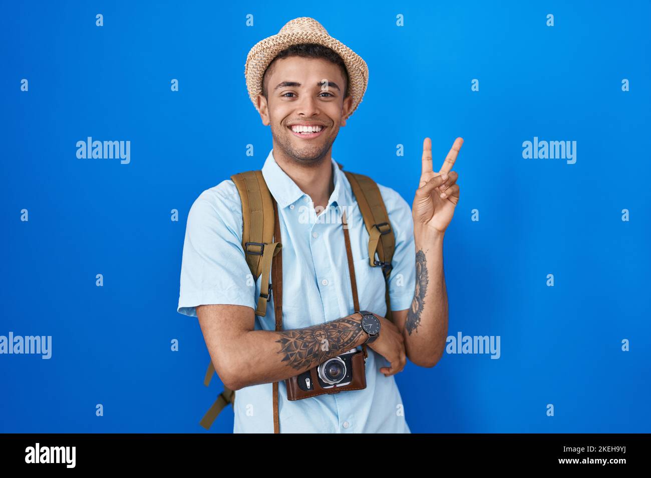 Brazilian young man holding vintage camera smiling with happy face ...