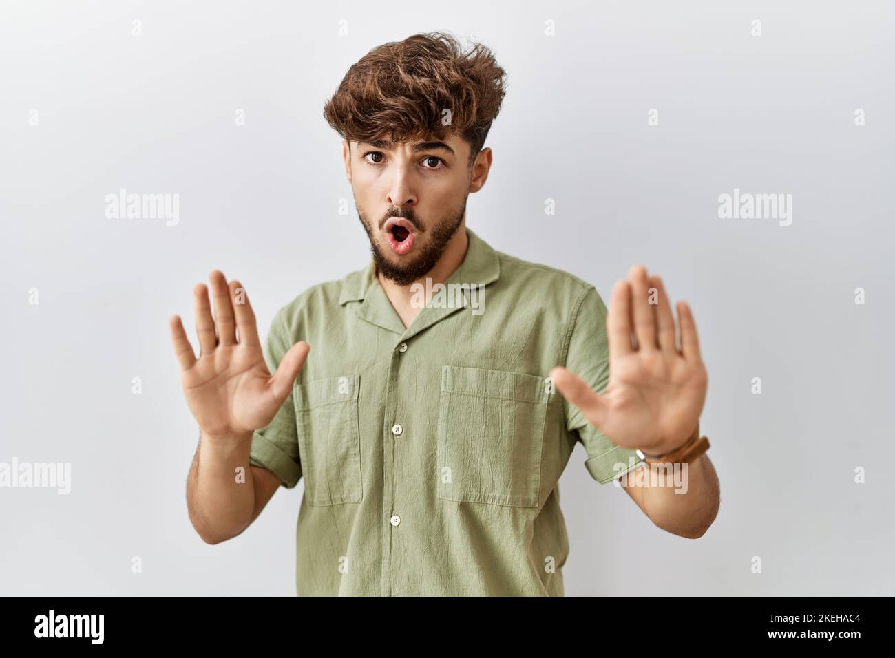 Young arab doctor man standing over isolated background moving away ...