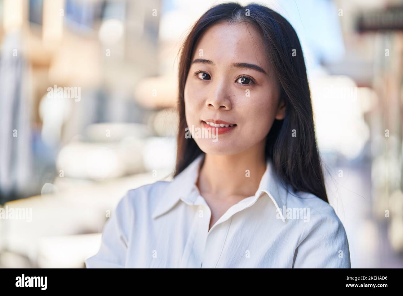 Young chinese woman smiling confident standing at street Stock Photo ...