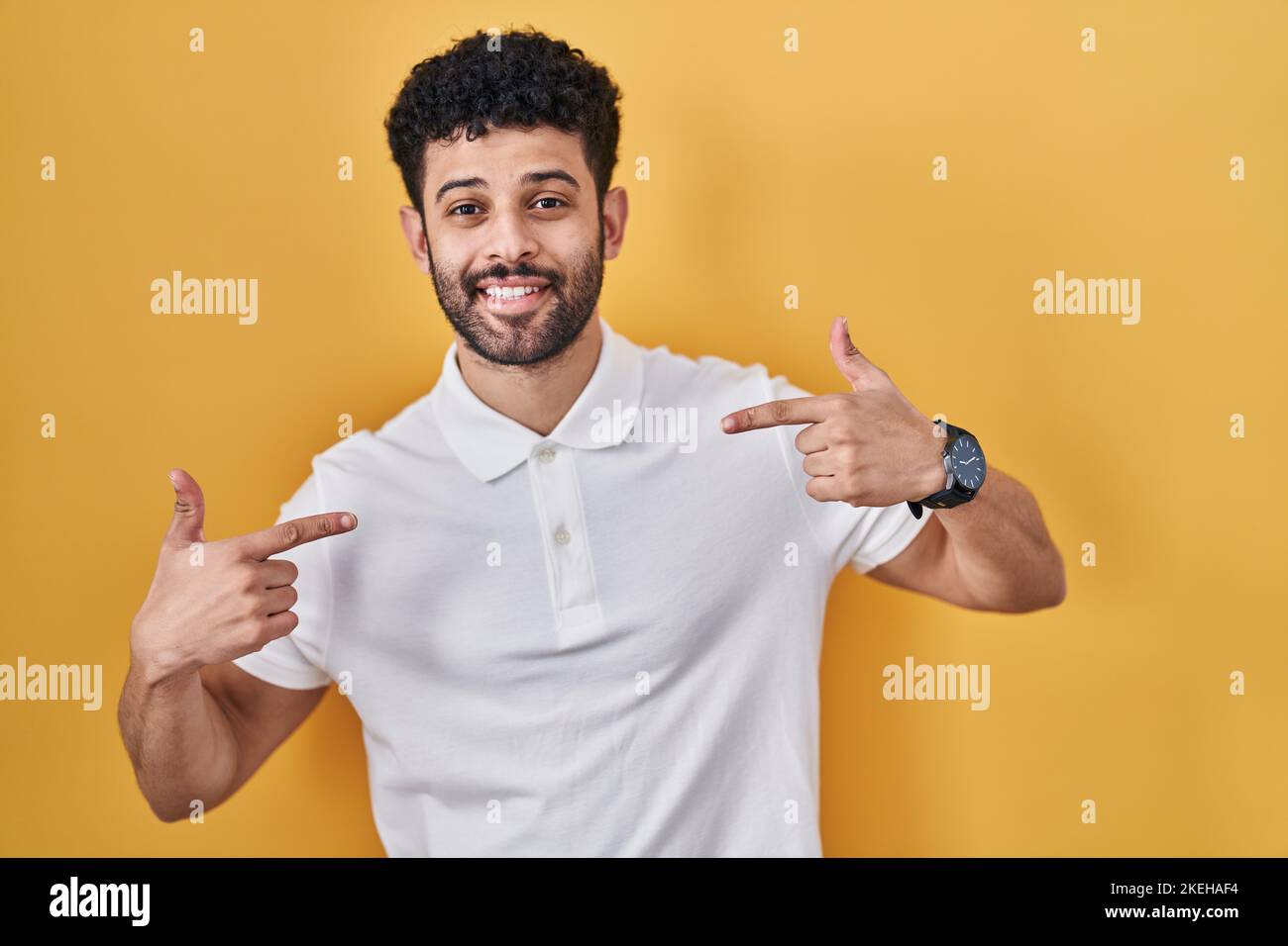 Arab man standing over yellow background looking confident with smile ...