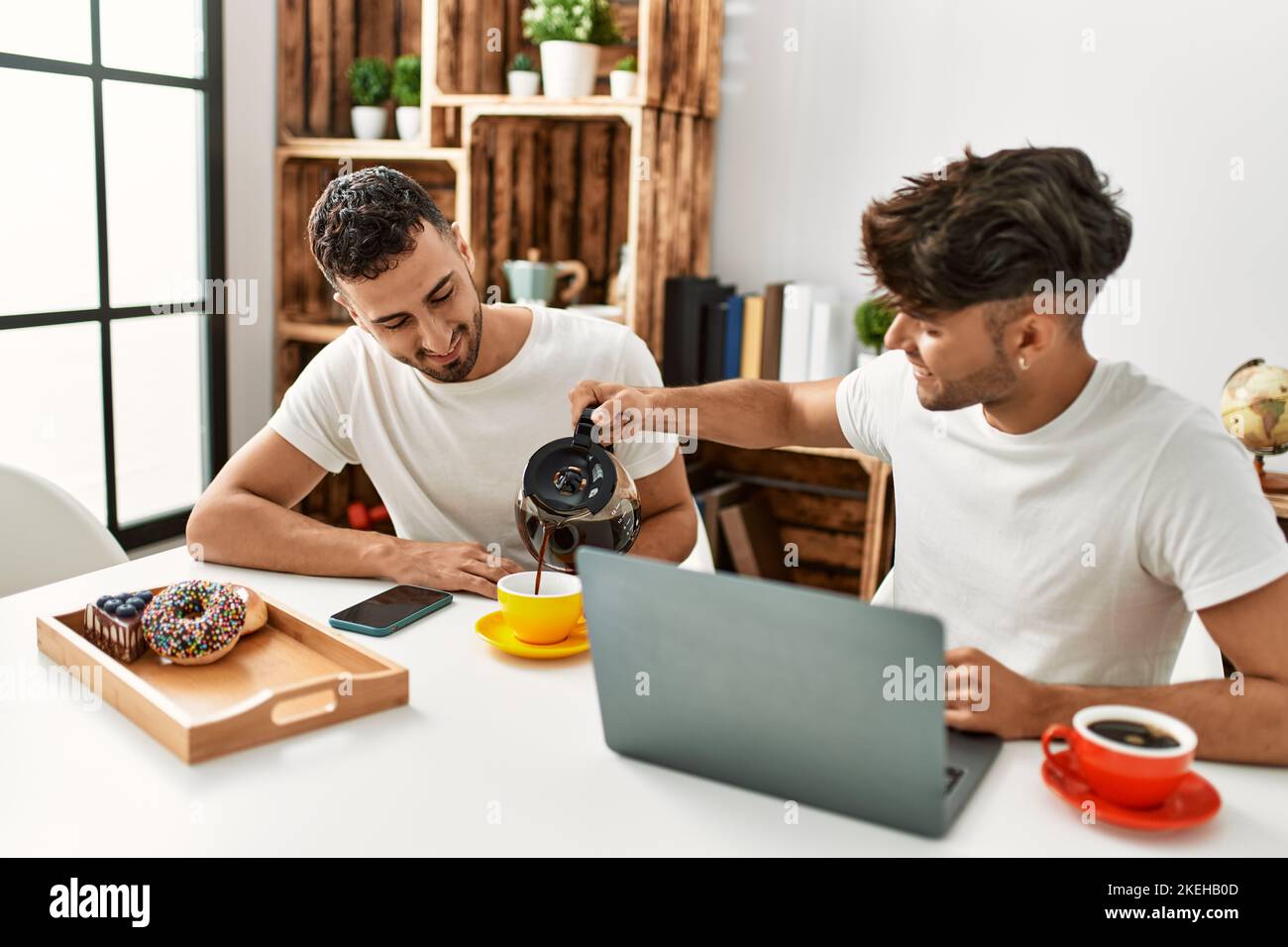 Happy gay couple having breakfast hi-res stock photography and images ...