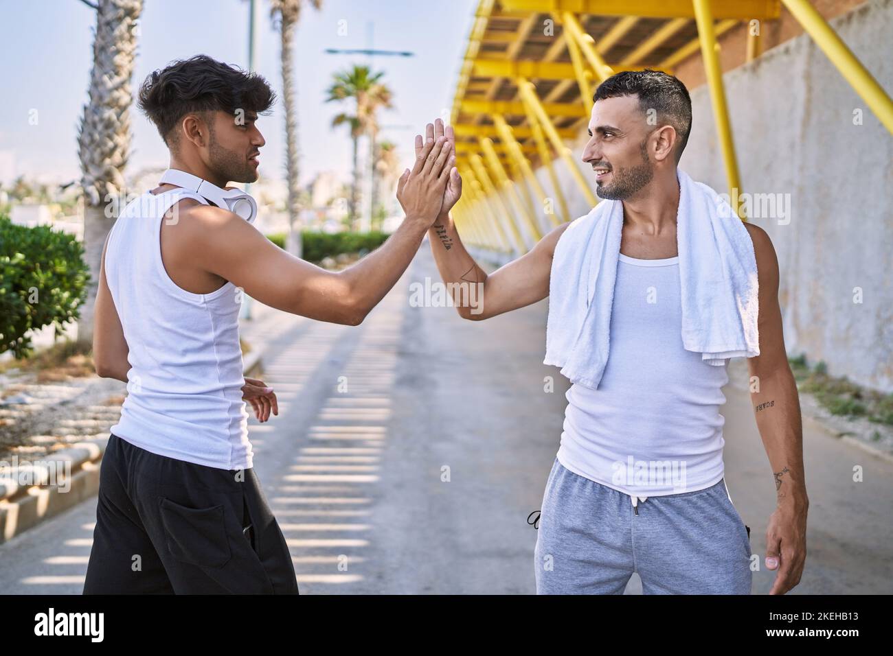 Two hispanic men couple smiling confident high five with hands raised ...
