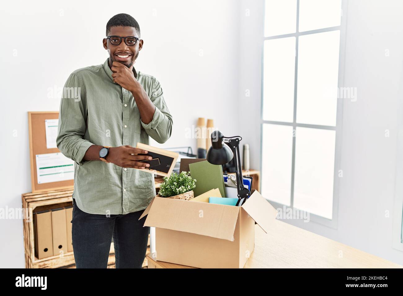 Young african american businessman unboxing box at the office with hand ...
