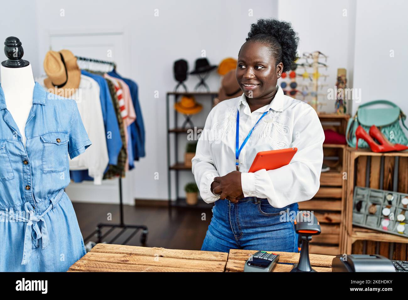Young african american woman shopkeeper smiling confident holding ...