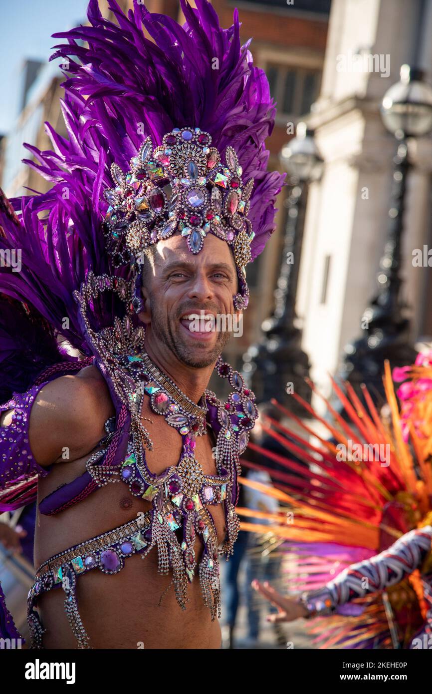 London, UK. 12th November 2022. A performer in a vibrant costume takes ...
