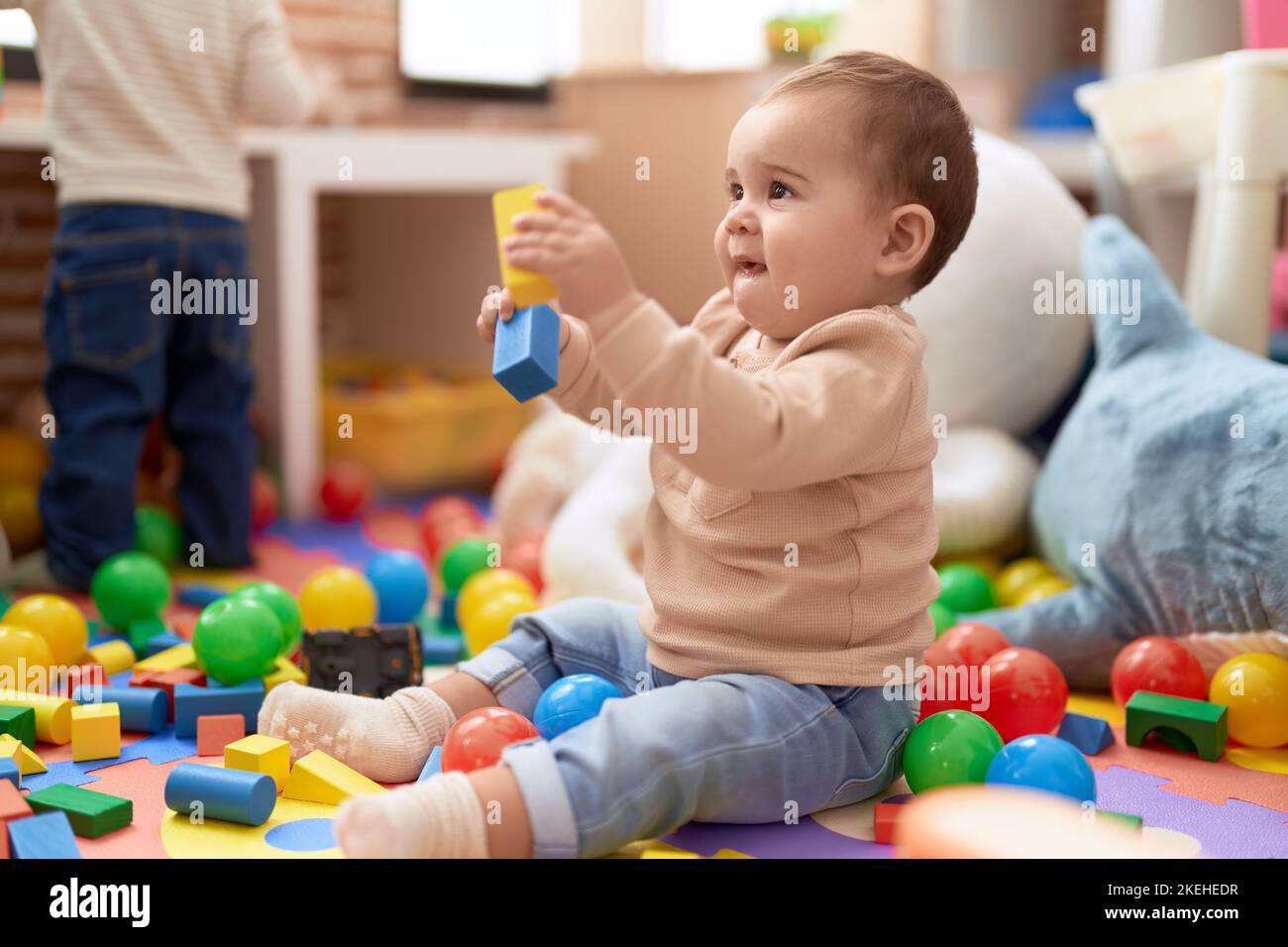 Adorable toddler playing with wooden construction blocks sitting on ...
