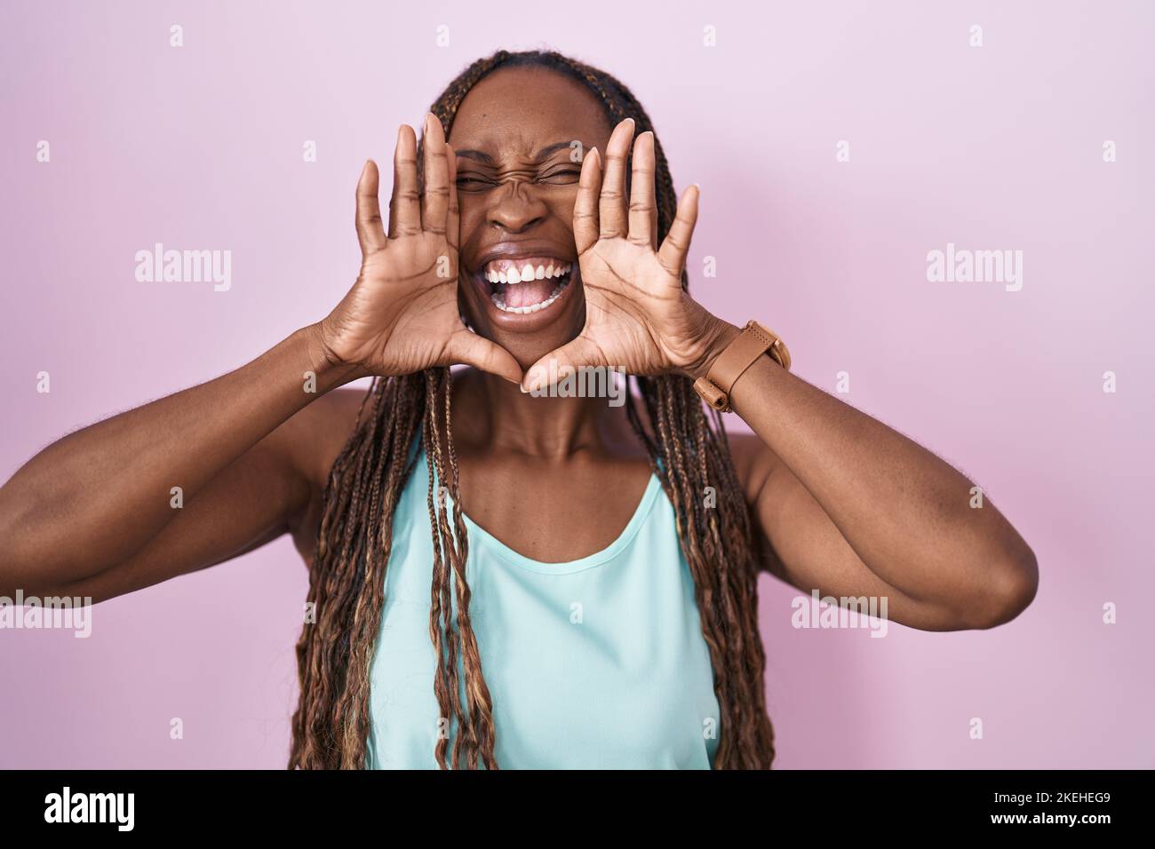 African american woman standing over pink background smiling cheerful ...
