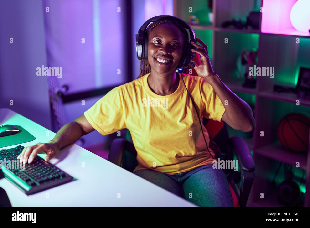 African american woman streamer smiling confident sitting on table at ...