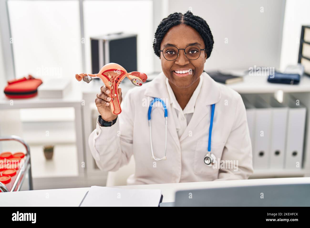 African american doctor woman holding anatomical model of female ...
