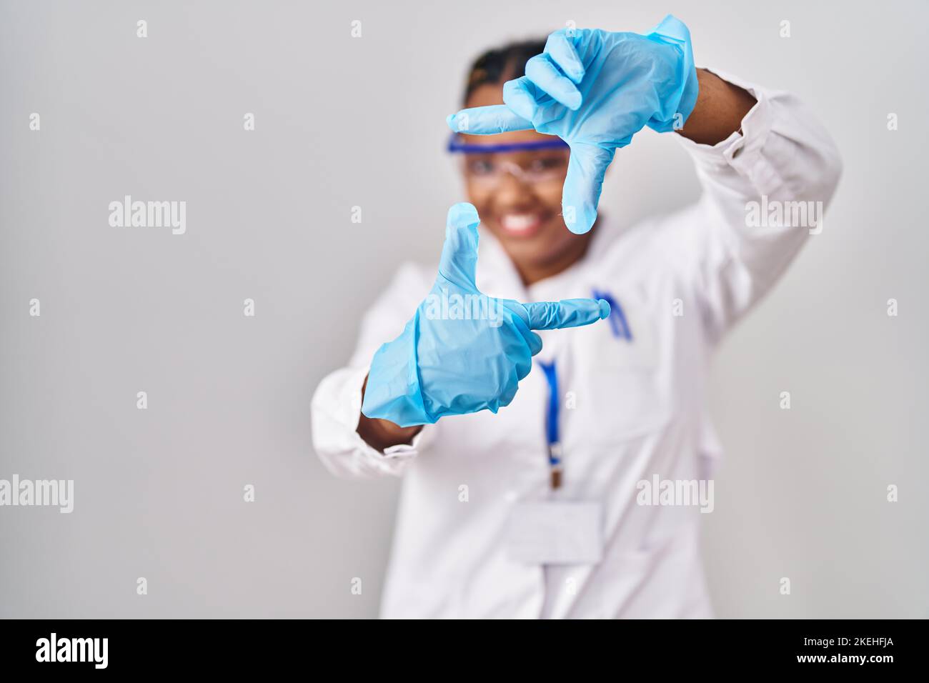 African american woman with braids wearing scientist robe smiling ...