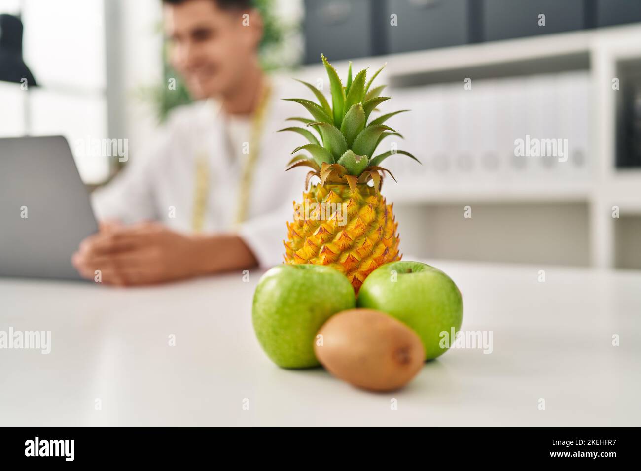Young hispanic man wearing dietician uniform working at clinic Stock ...
