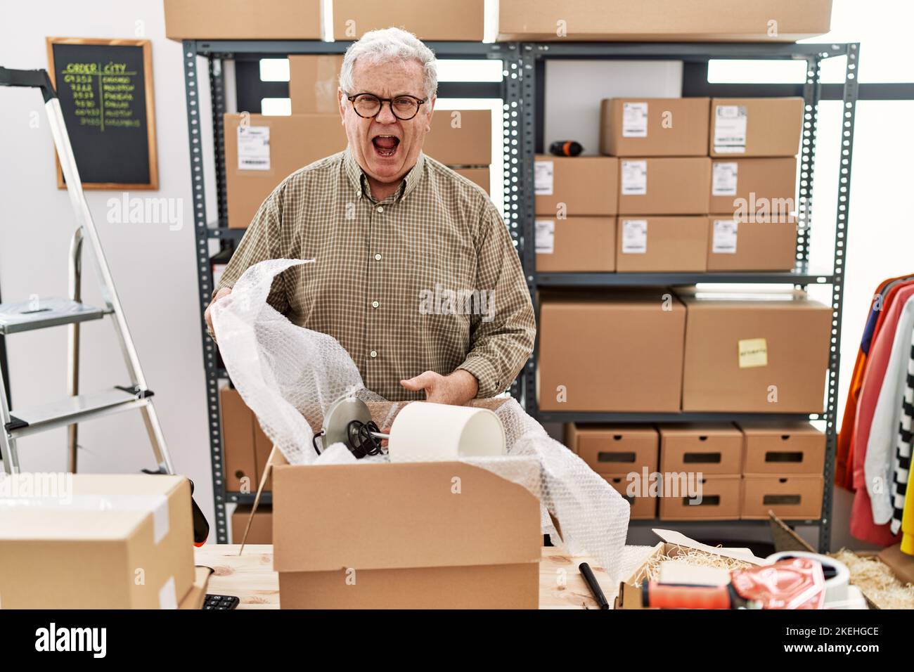 Senior caucasian man working at small business ecommerce packing order ...