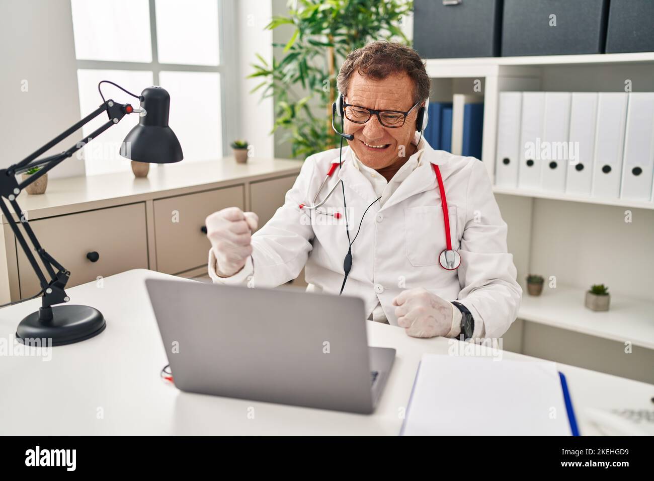 Senior doctor man working on online appointment angry and mad raising ...