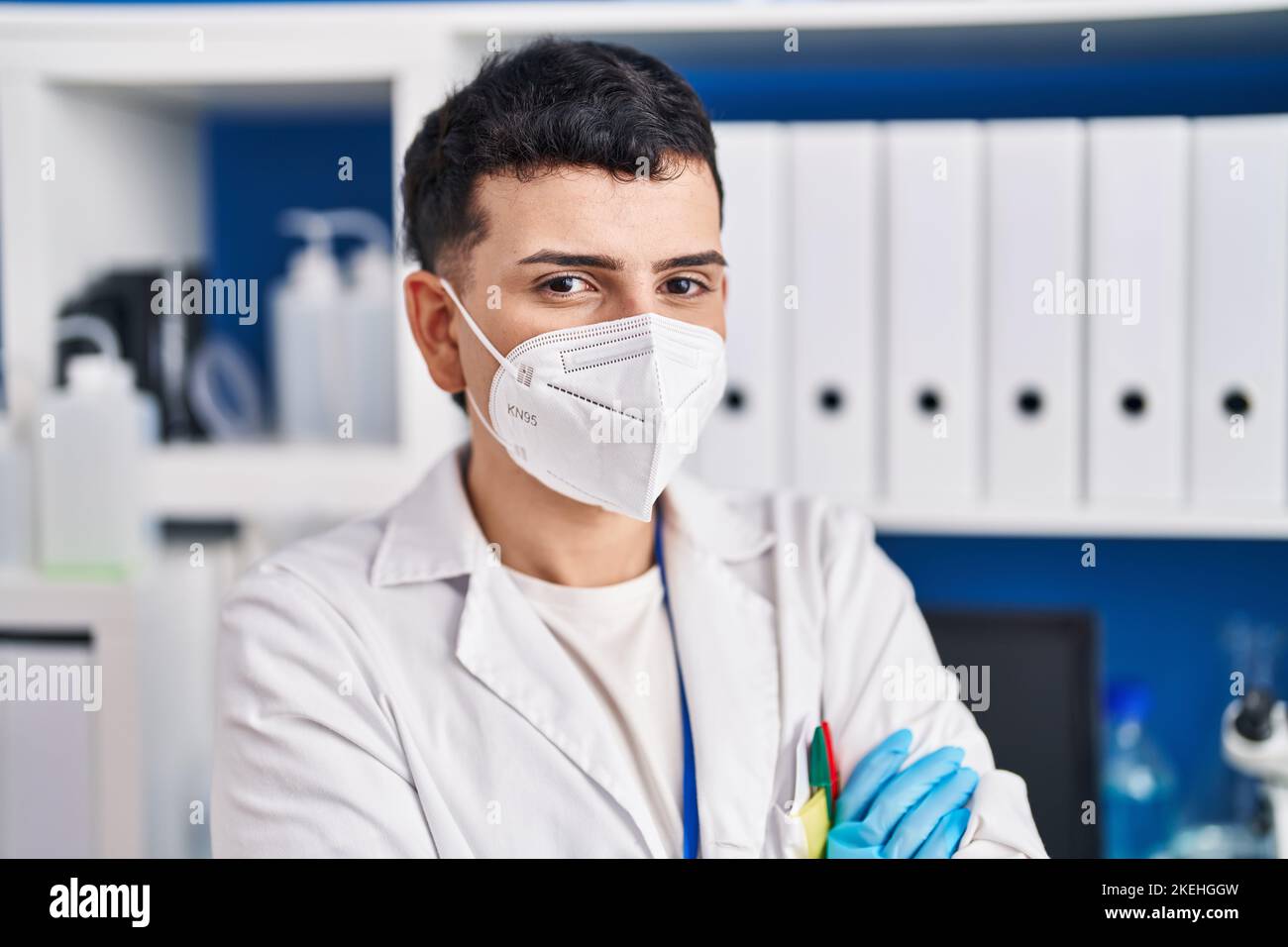 Young non binary man scientist wearing medical mask at laboratory Stock ...