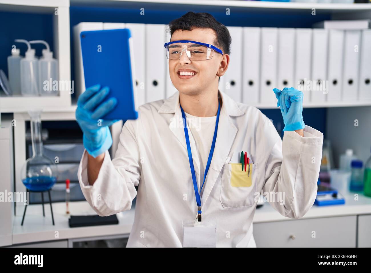 Non binary person working at scientist laboratory using tablet ...