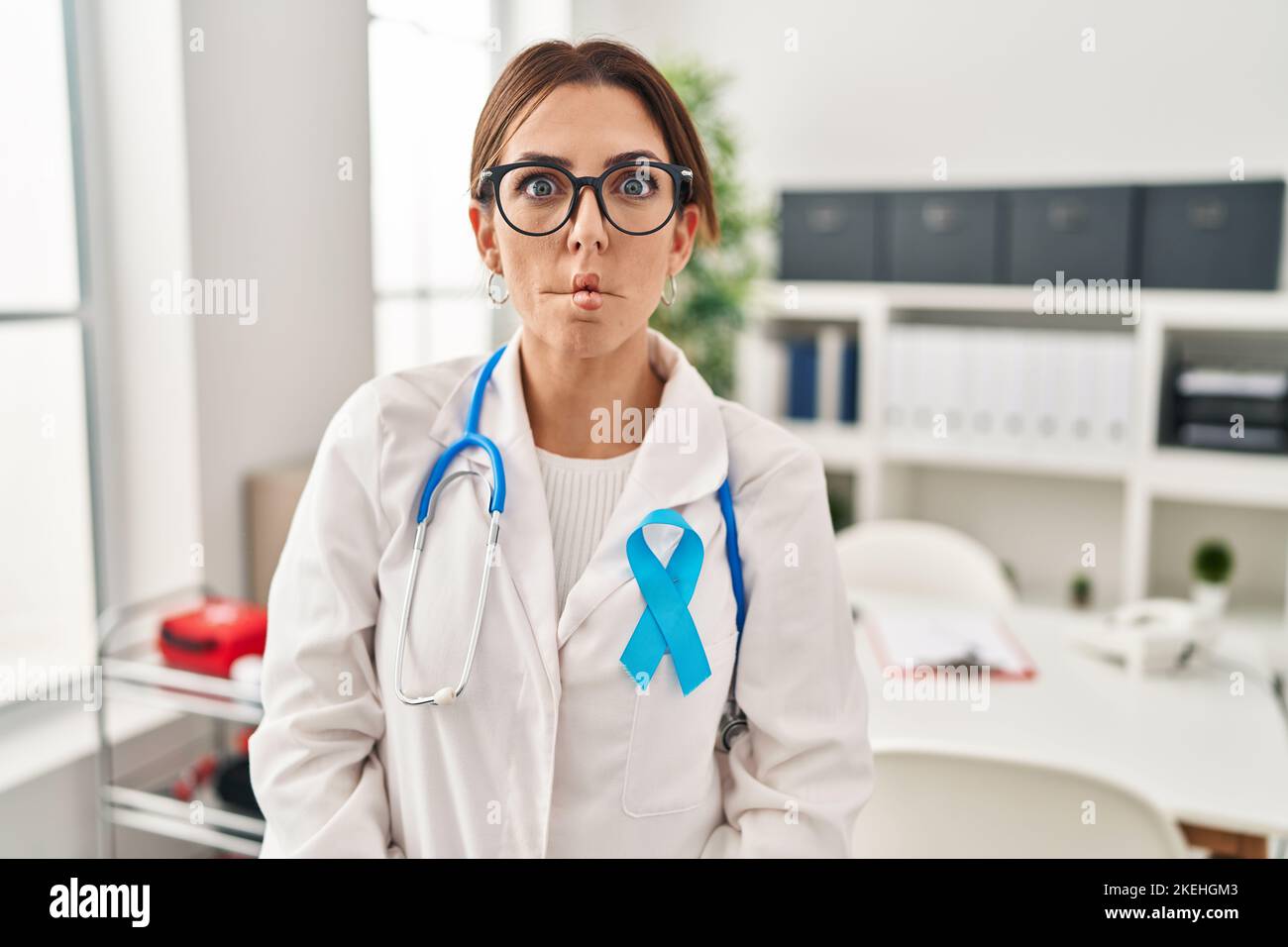 Young brunette doctor woman wearing stethoscope at the clinic making ...