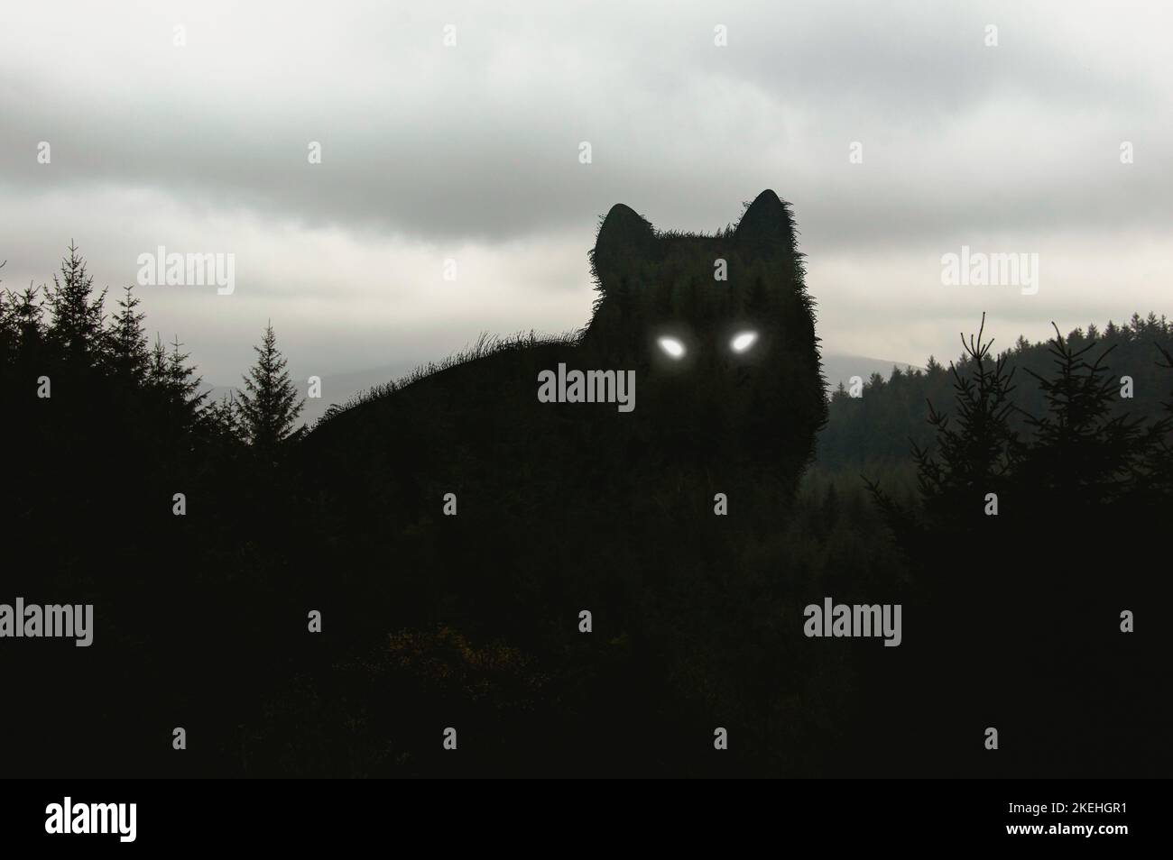 A silhouette of a giant wolf with glowing eyes. Standing above a winter ...