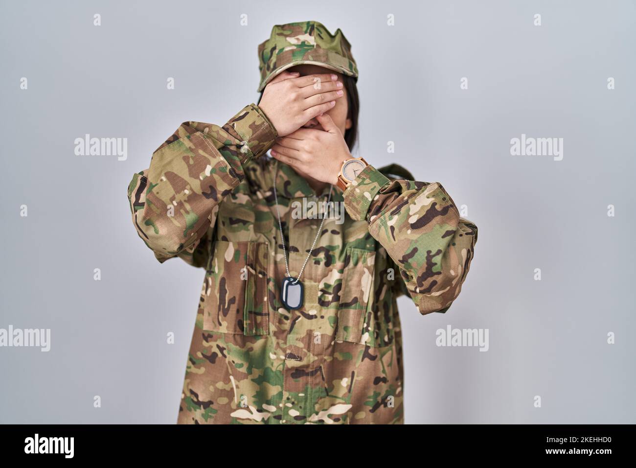 Young South Asian Woman Wearing Camouflage Army Uniform Covering Eyes