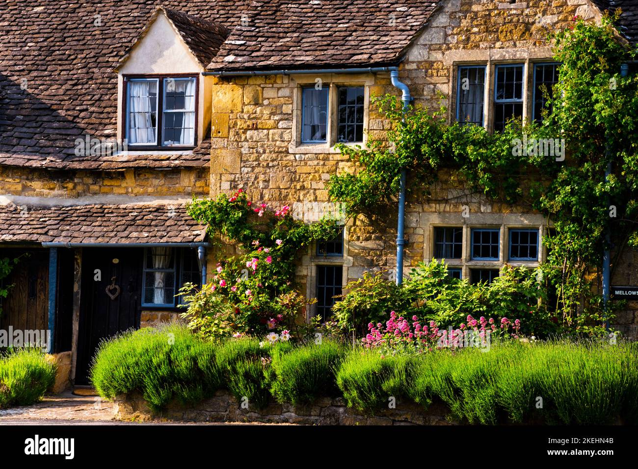 Bountiful plantings, mullioned windows and stone roofl in Broadway ...
